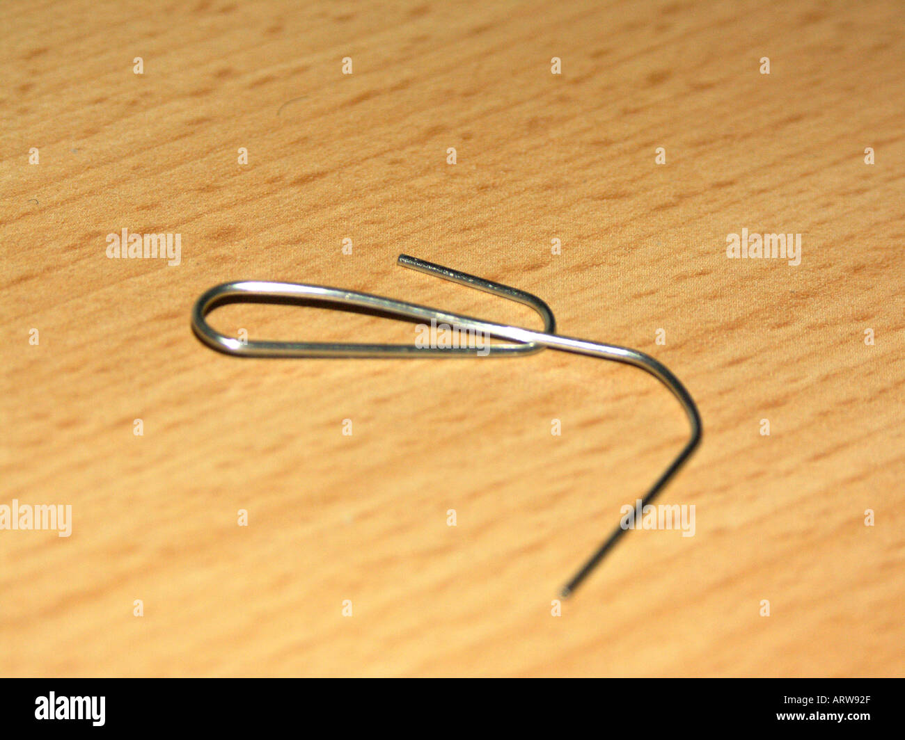 Bent Paperclip on Desk Stock Photo - Alamy
