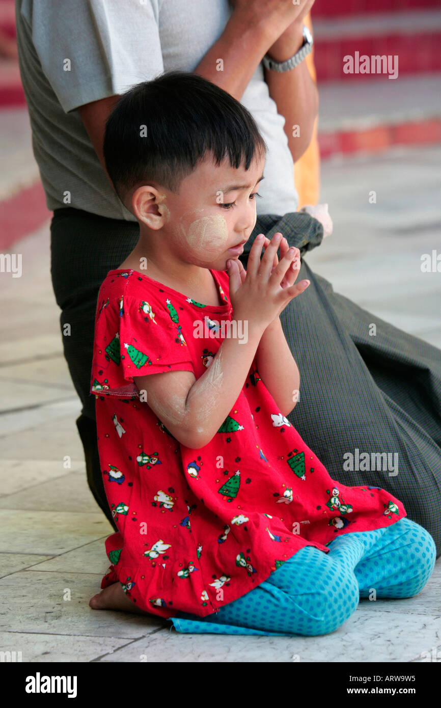 Burmese child with father at prayer at the Sule Pagoda, Rangoon ...