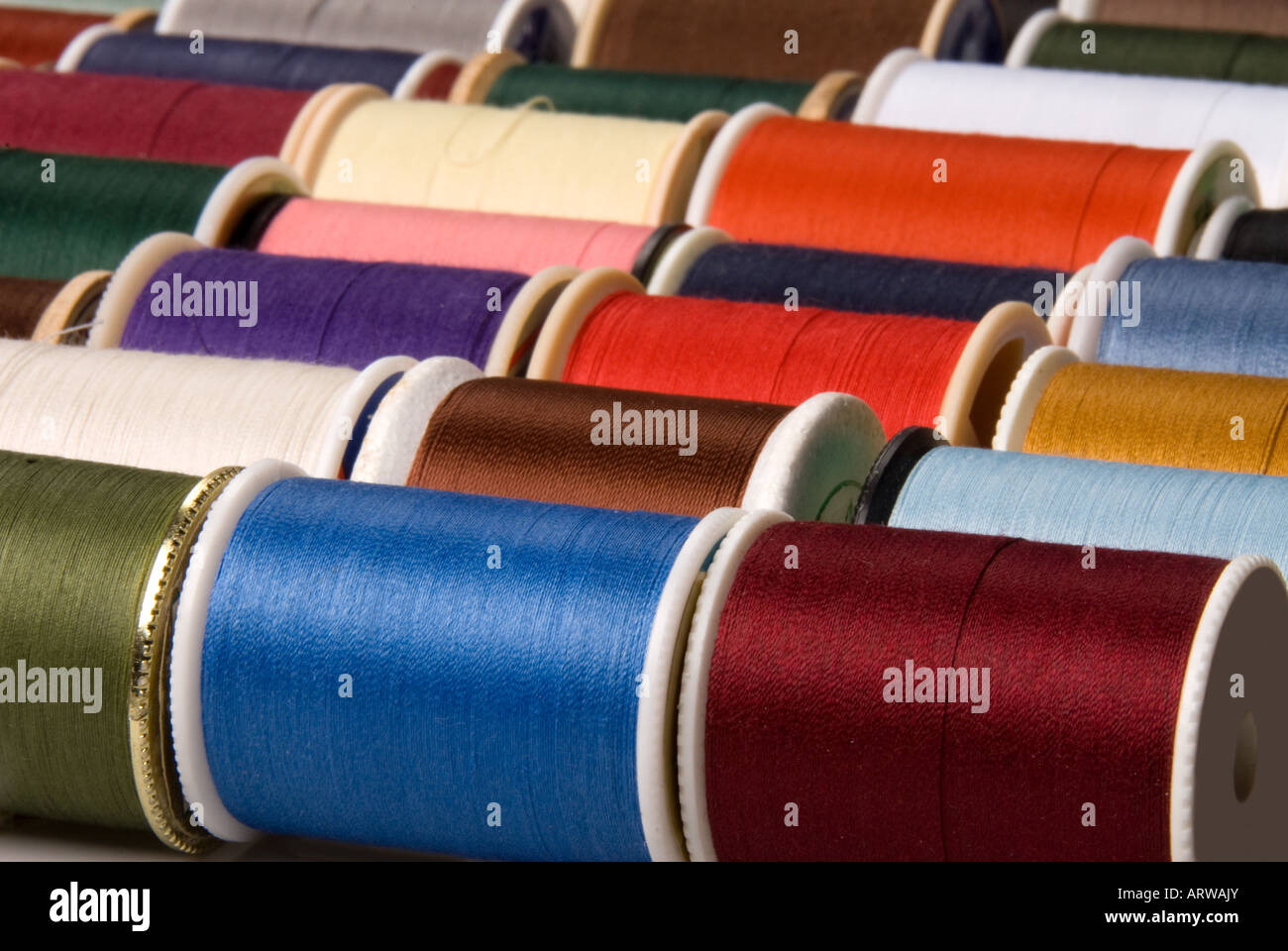 The concept of sewing and embroidery is highlighted by colorful spools ...