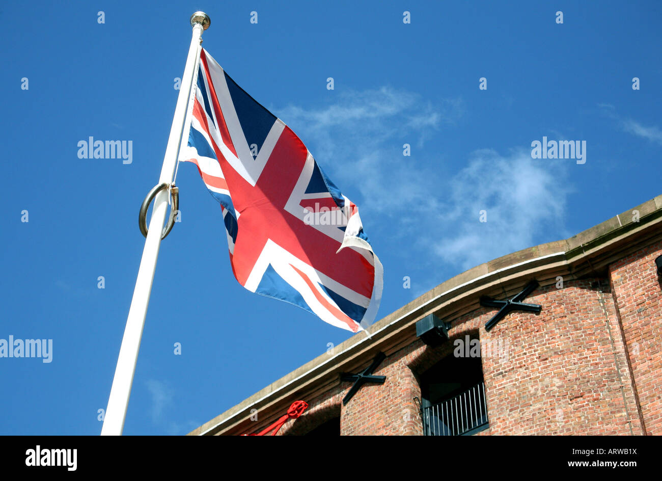 Union Jack flag flies over Albert Dock in Liverpool Stock Photo - Alamy