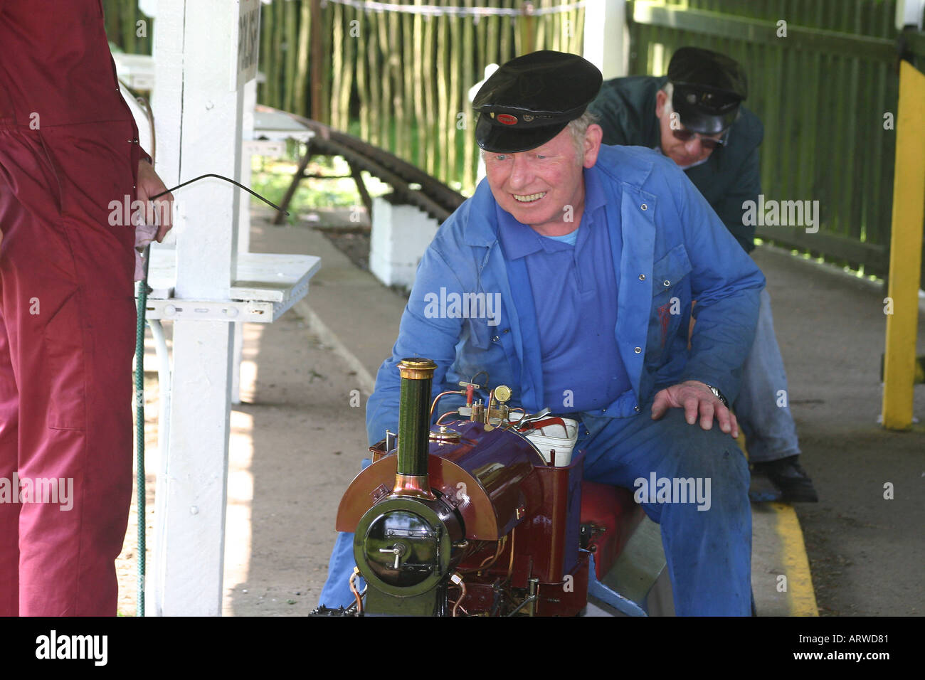 Man driving model steam locomotive Stock Photo - Alamy