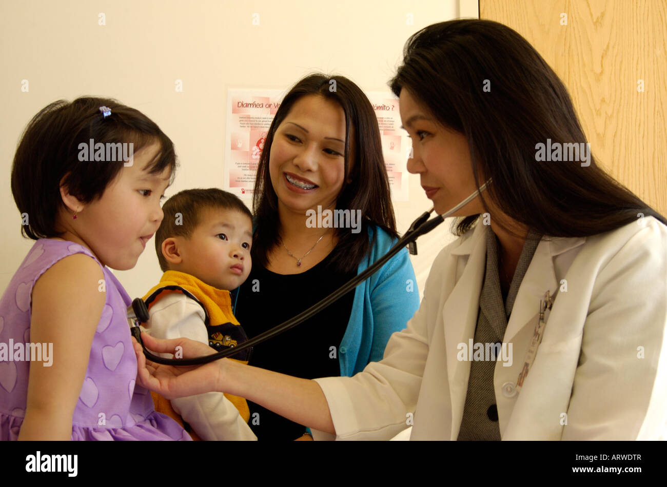 Asian american girl gets medical exam at doctors office Stock Photo - Alamy