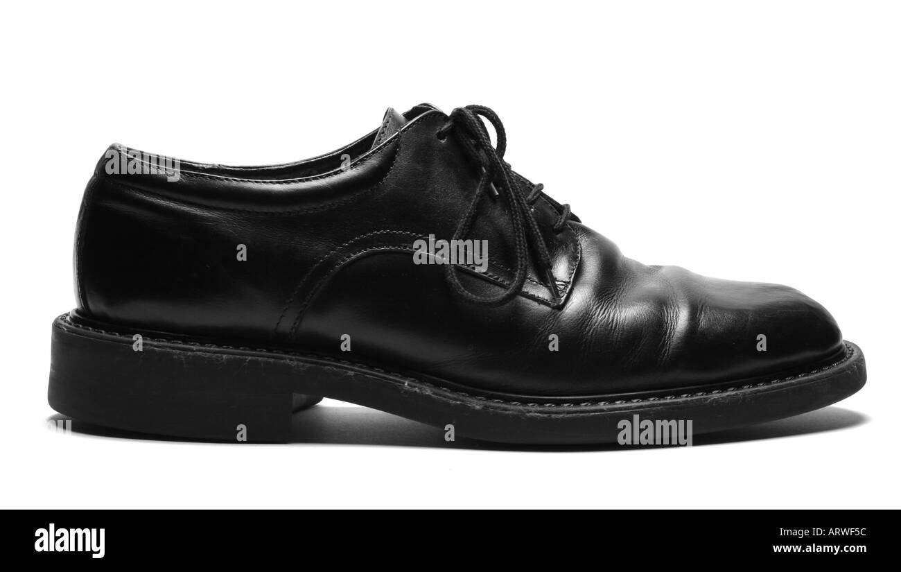 Single black leather shoe against a white background Stock Photo - Alamy