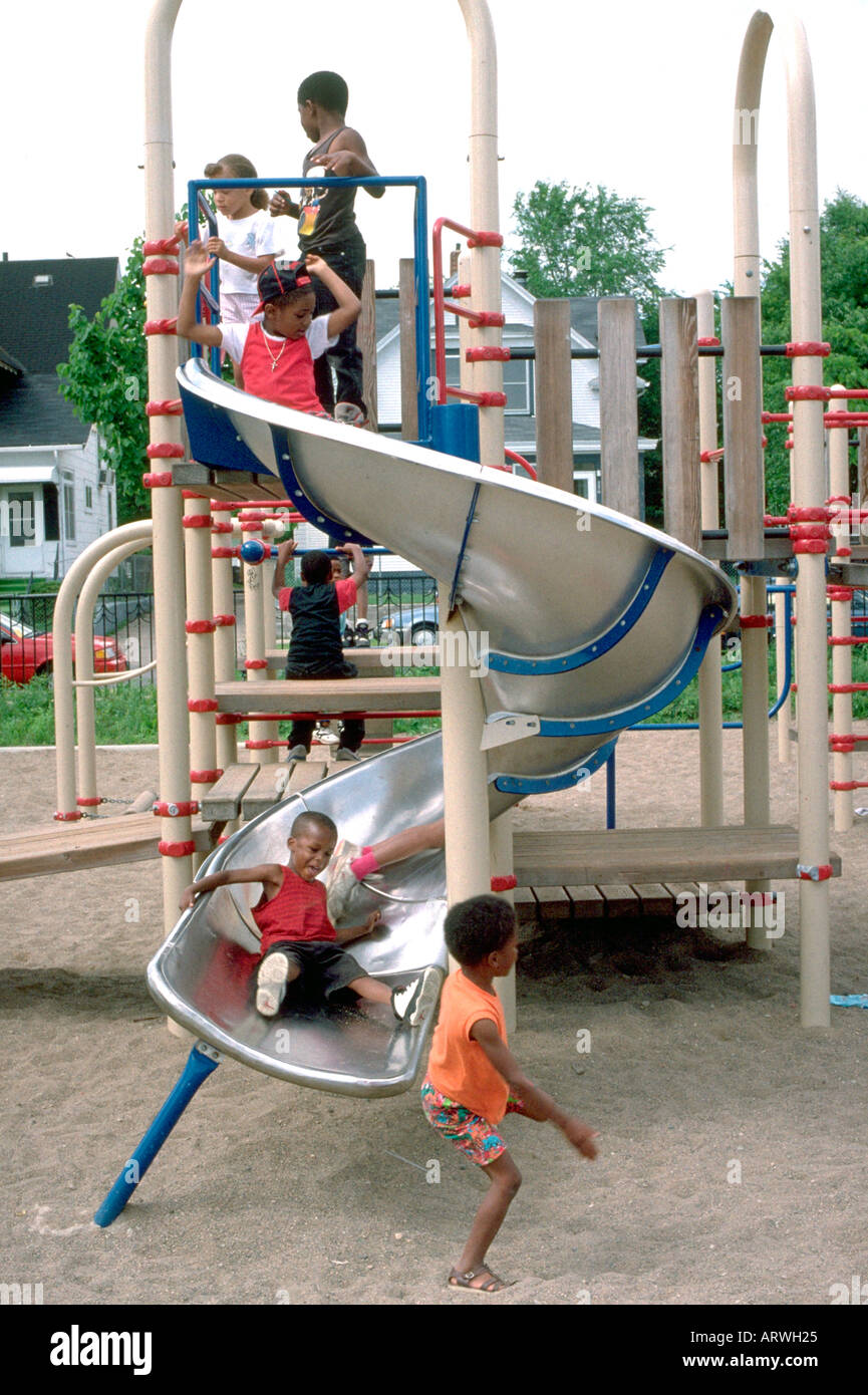 Friends ages 5 and 7 playing on slide in playground. Minneapolis ...