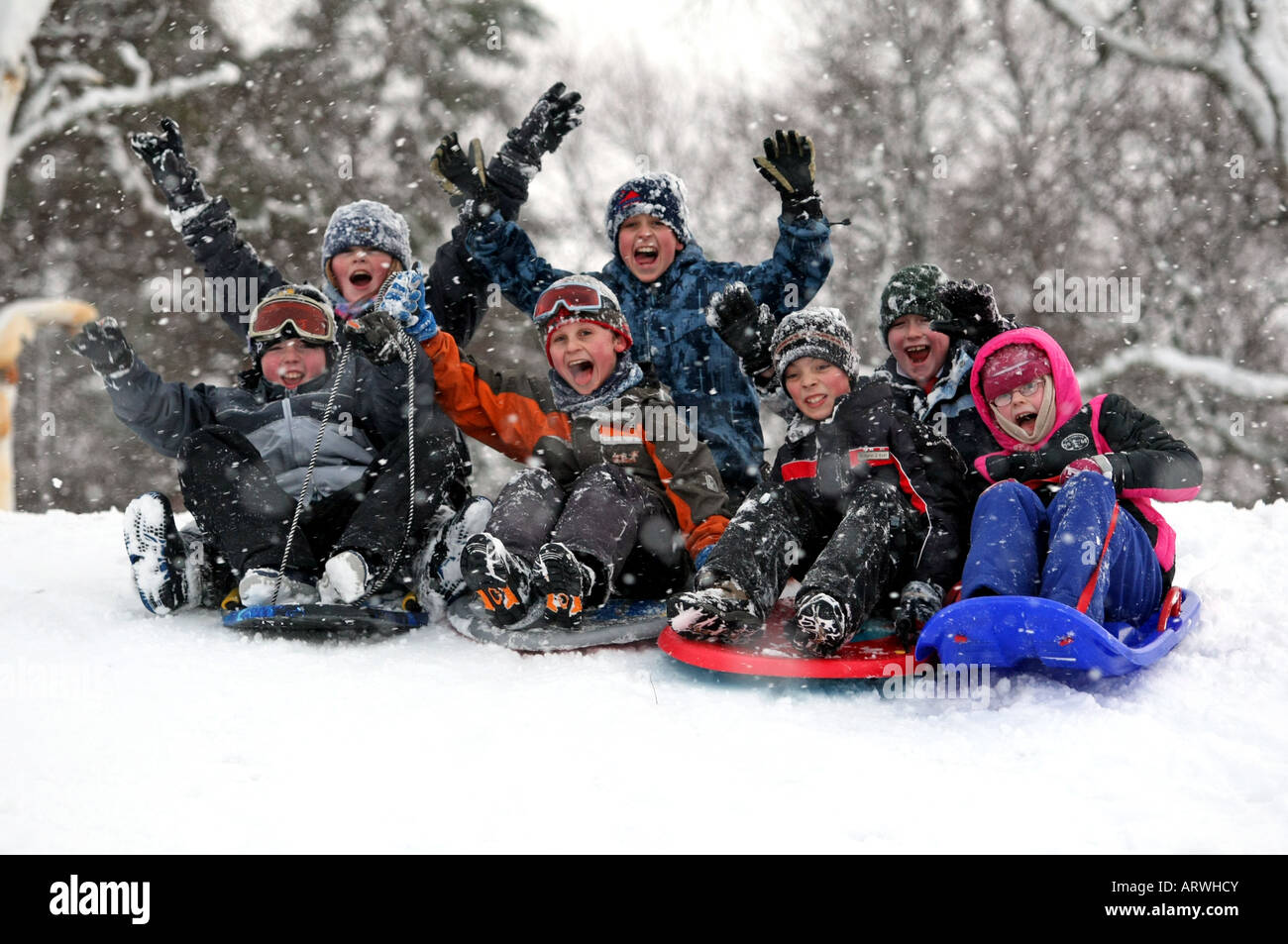 Children having fun sledging in snow near Braemar, Aberdeenshire ...