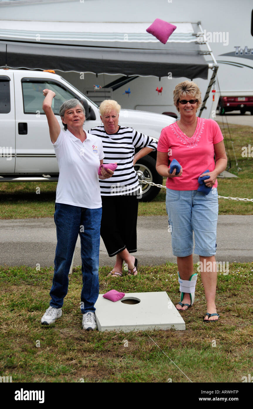 Female Senior retired citizens play game of bean bag toss in a ...