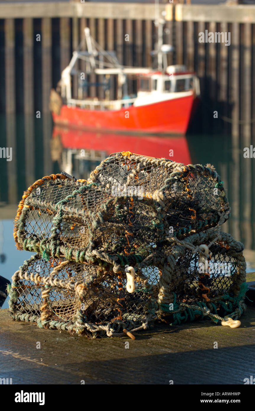 Fishing boat and lobster pots sitting on the quayside Portavogie ...