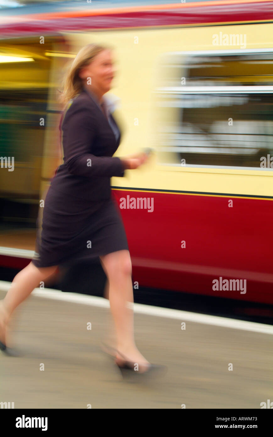 Business woman running on train platform Stock Photo - Alamy