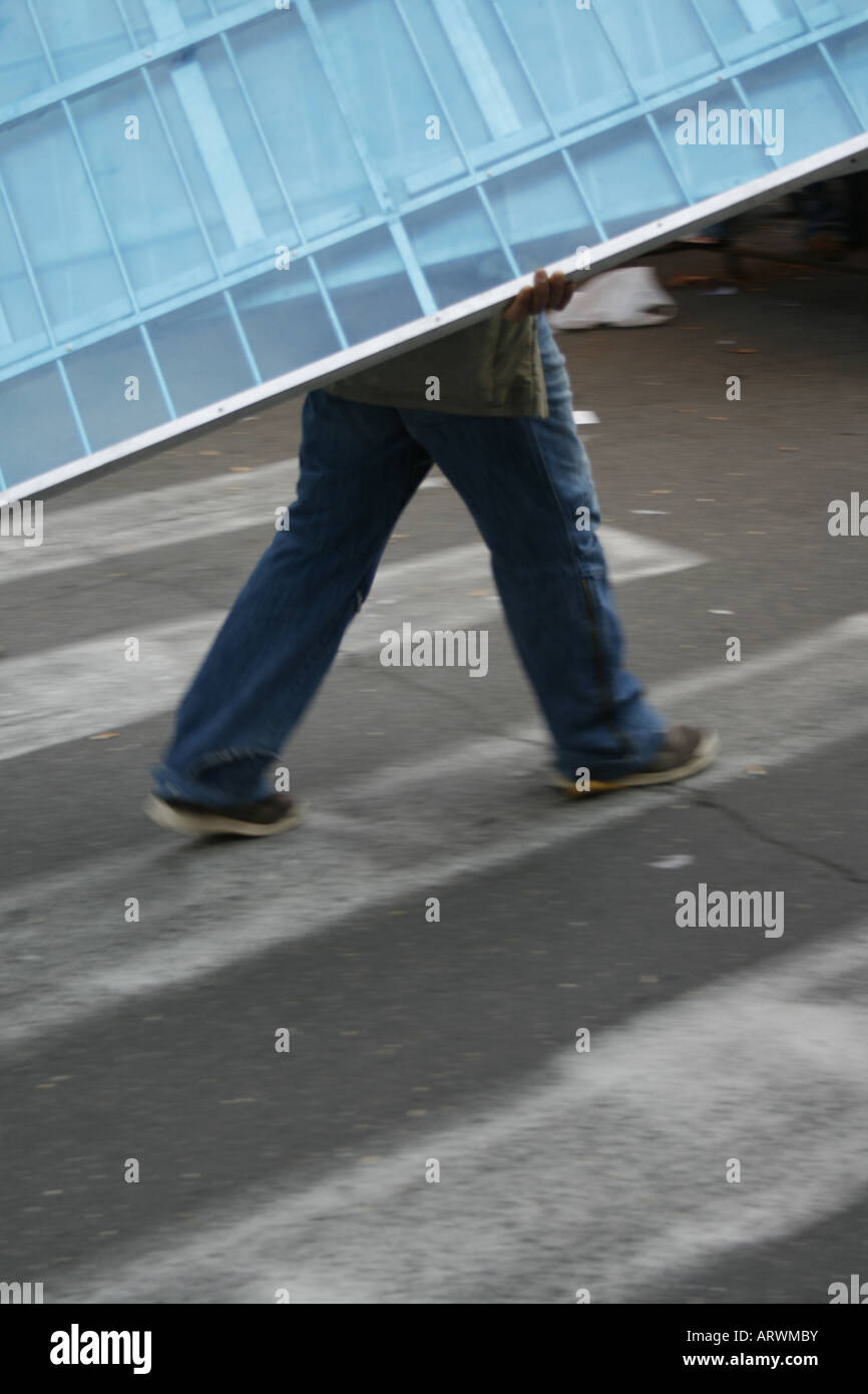 man carrying table in street road in city town Stock Photo - Alamy