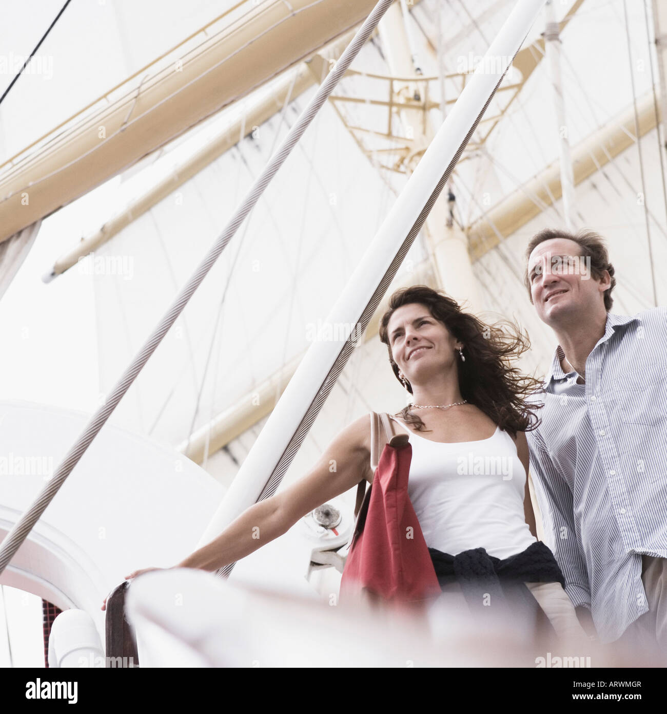 Low angle view of a mid adult couple standing with their arms ...
