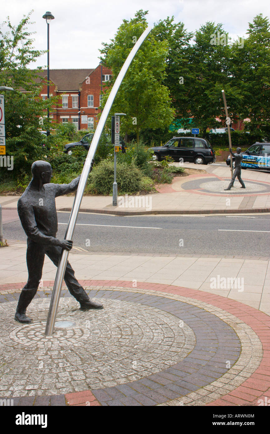 Statues of men with bent poles across road opposite Basingstoke train ...