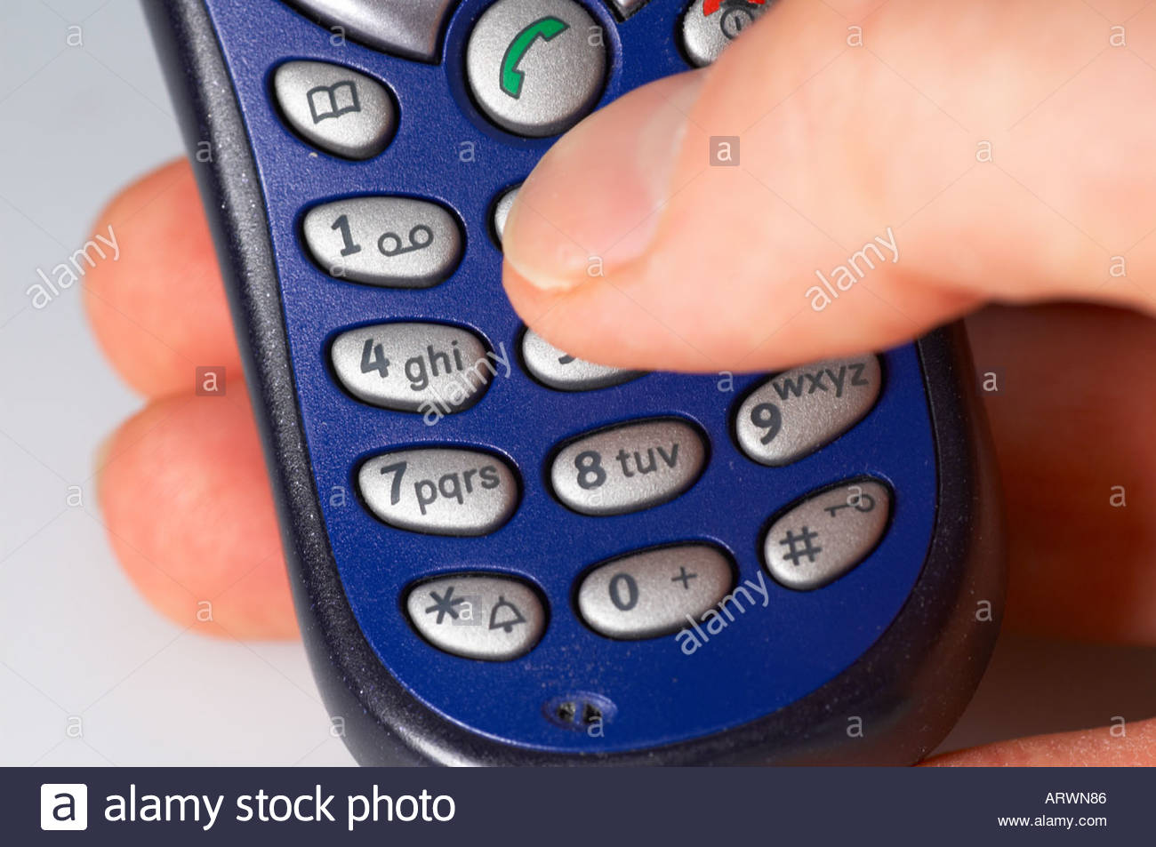 A person dialls a number on a blue mobile phone Stock Photo - Alamy