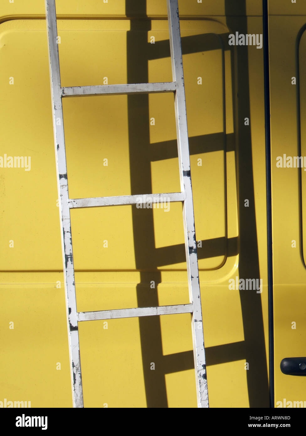 ladder against yellow van Stock Photo - Alamy