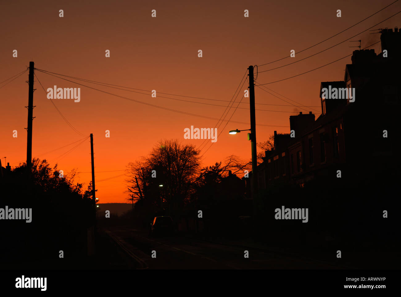 Silhouetted urban street scene with stunning red sky at Hinderwell Lane ...