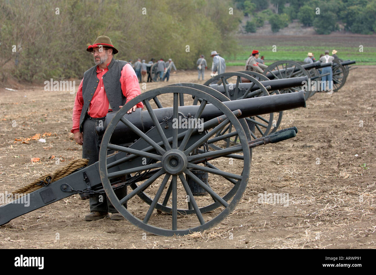Cannoneer preparing for battle in cannon line at Civil War reenactment ...
