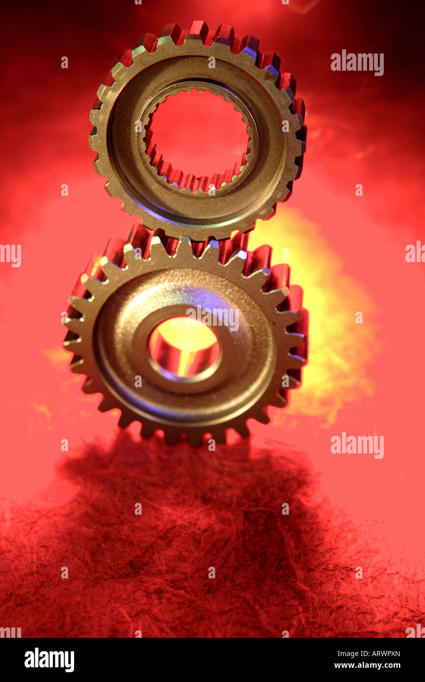 Two gears meshing together Stock Photo - Alamy