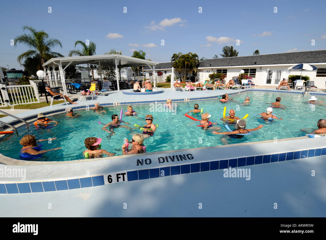 Senior citizens enjoying retirement in a resort swimming pool Stock ...