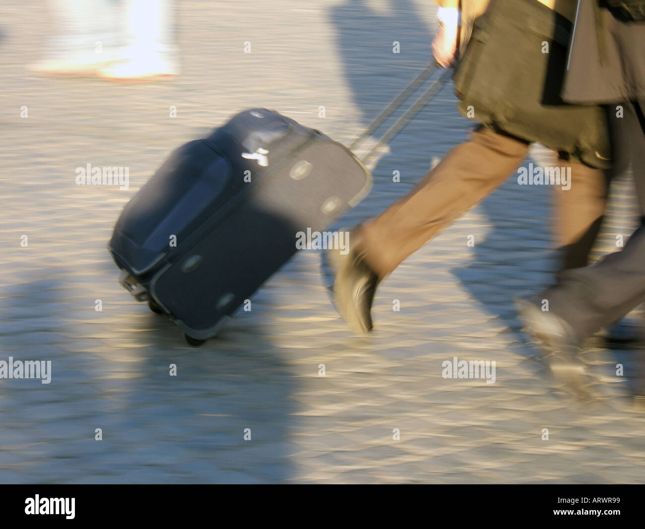 man pulling trolley case Stock Photo - Alamy