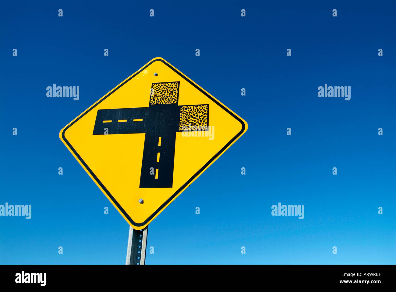 Street traffic sign alerting drivers to connecting gravel unpaved roads ...