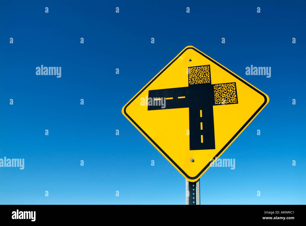 Street traffic sign alerting drivers to connecting gravel unpaved roads ...