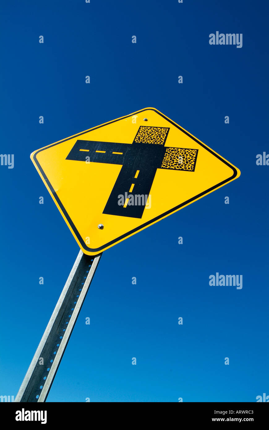 Street traffic sign alerting drivers to connecting gravel unpaved roads ...