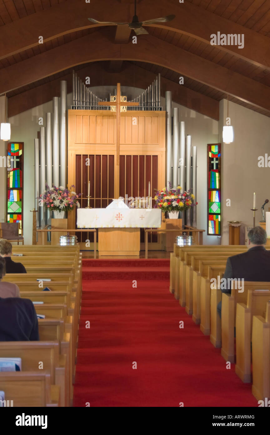Church interior during Sunday morning worship showing aisle and altar ...