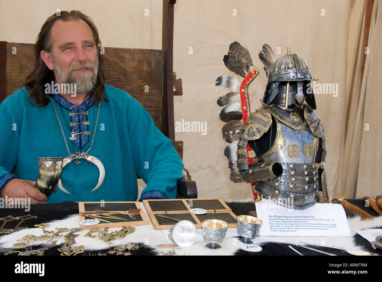 Medieval Chief in Blue Smock with Horn Cup and Necklace Sits on Market ...