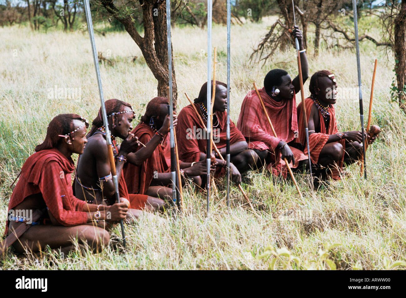 A relaxed group of Maasai moran, or warriors, in the Kenya grasslands ...