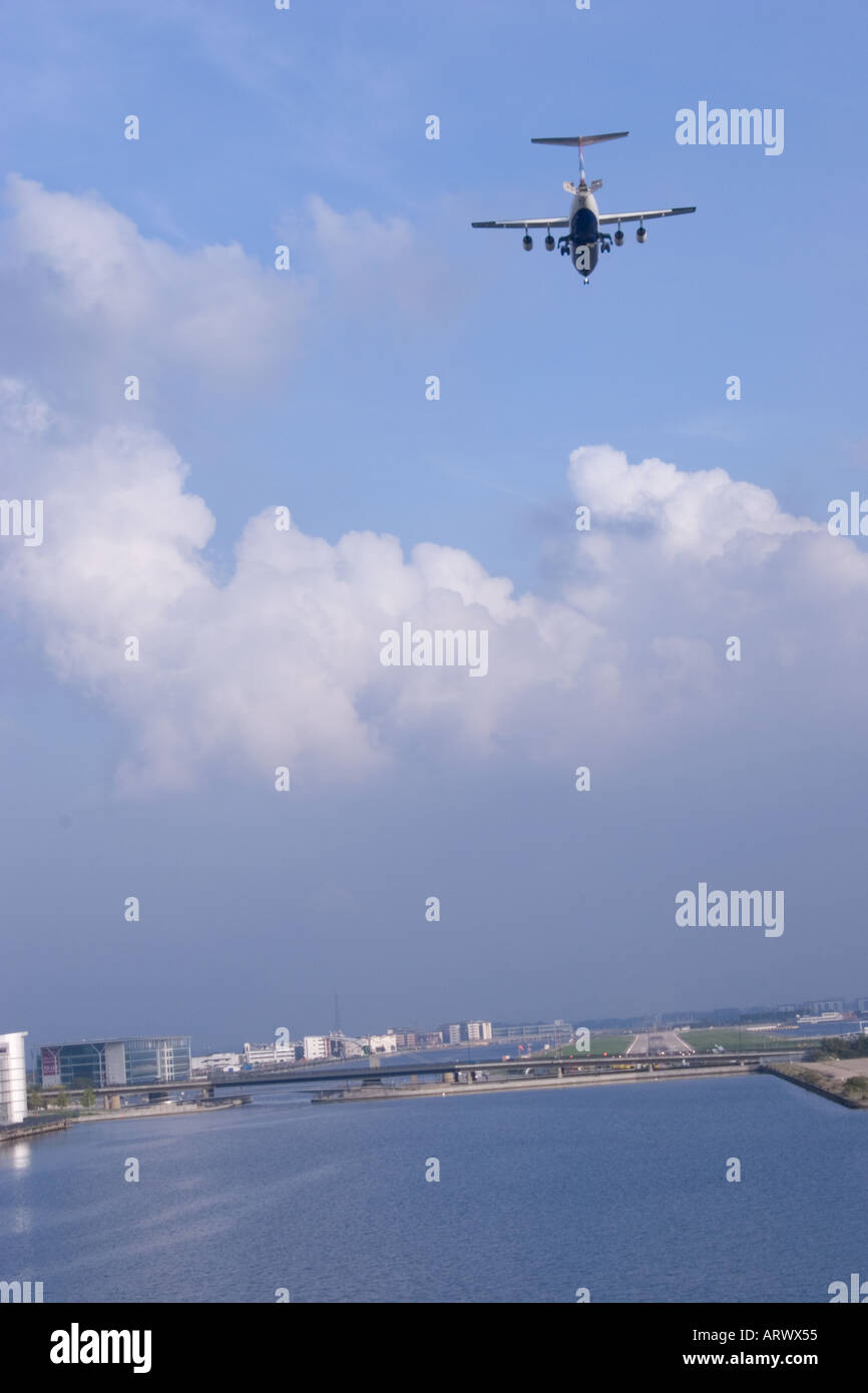 low flying aircraft flying over river Thames on approach to Londons ...