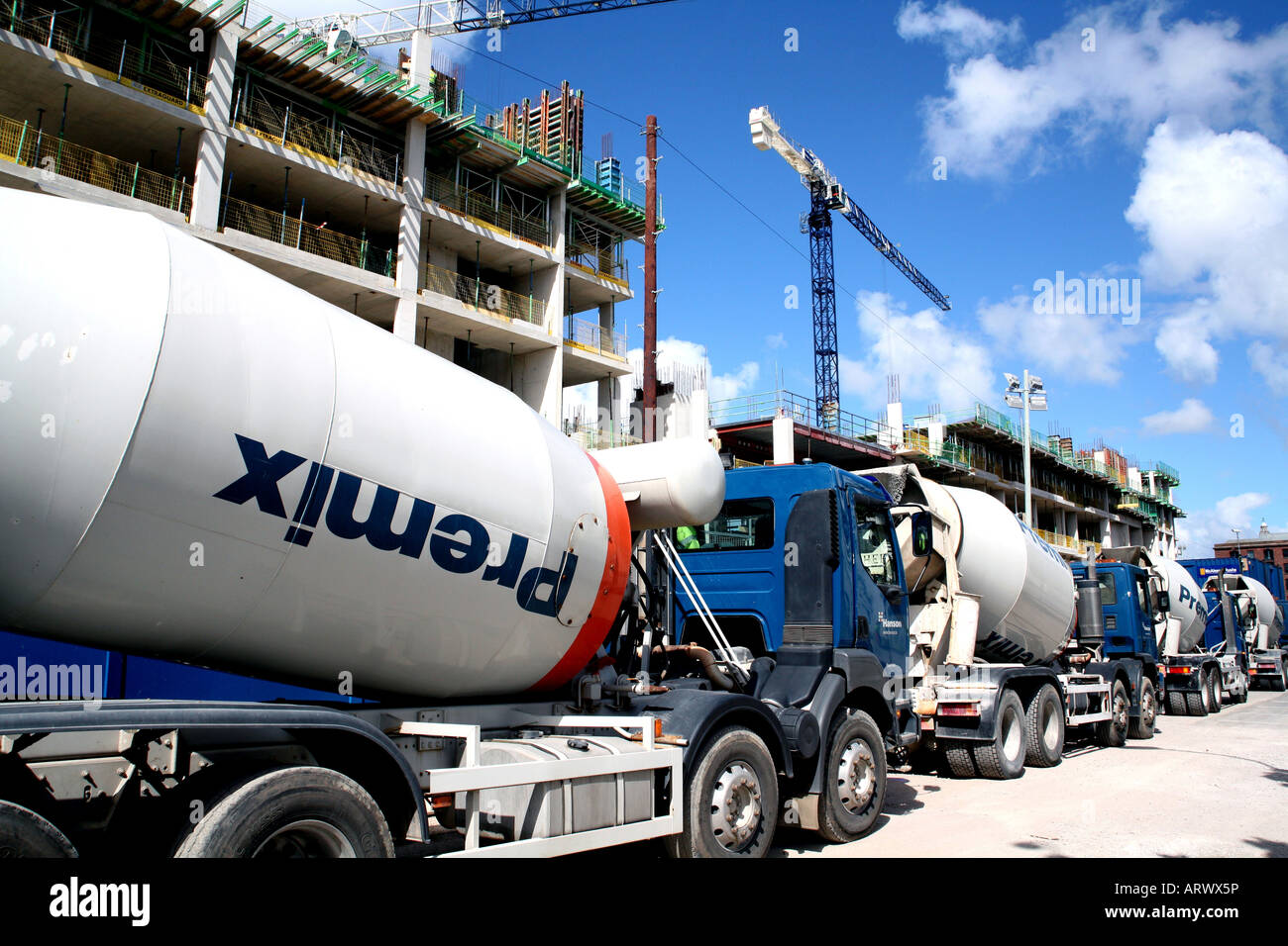 Ready mixed concrete lorries queue up outside huge construction site in ...