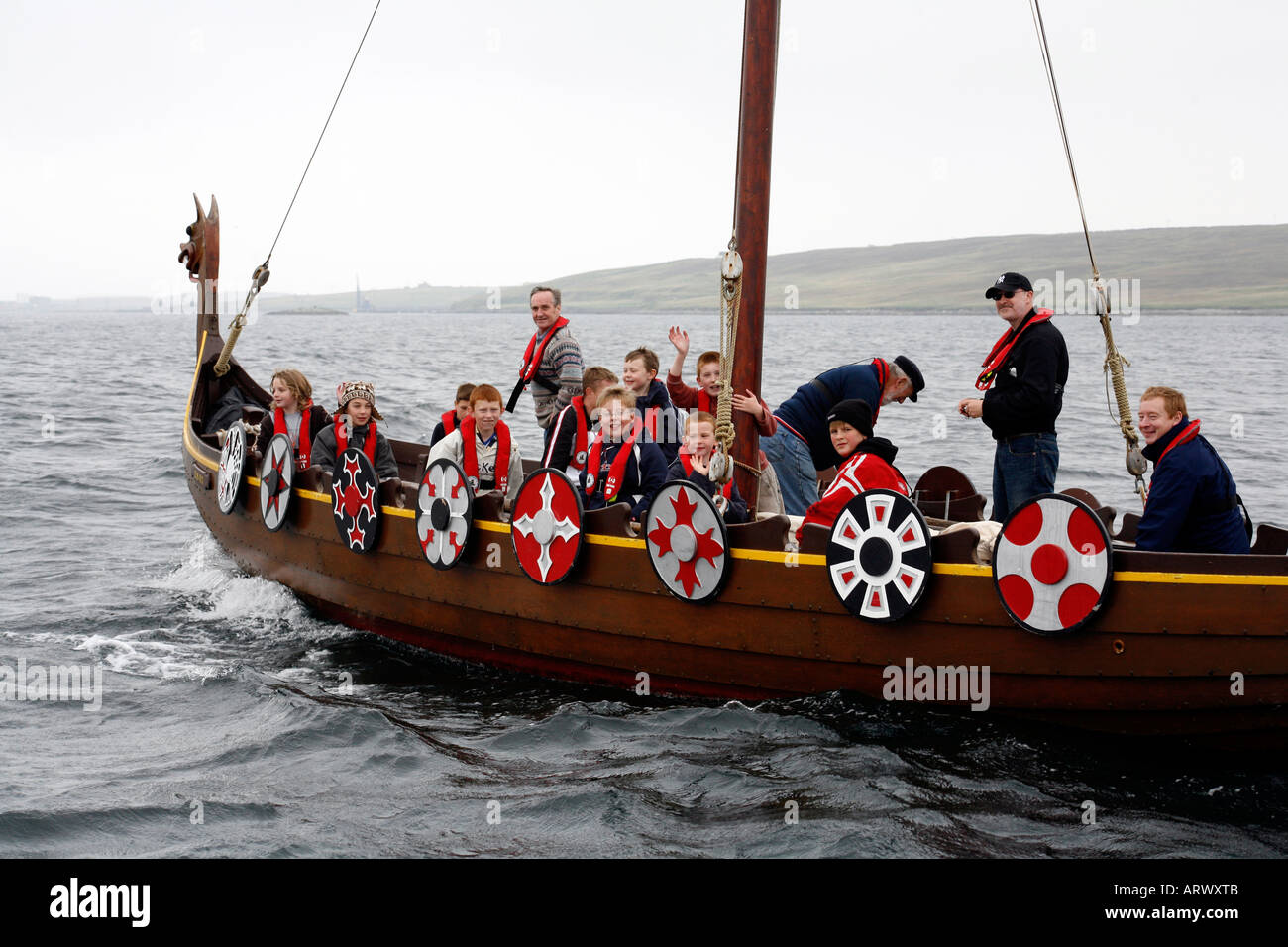School children sailing in mock Viking boat, Lerwick Harbour, Shetland ...