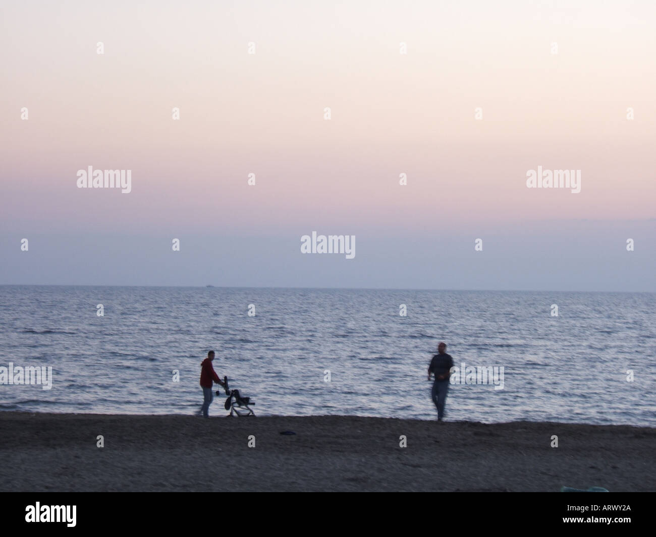person pushing pram on beach Stock Photo - Alamy