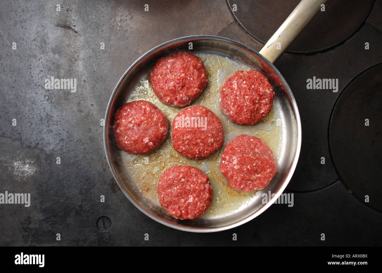 Five hamburgers in a frying pan Stock Photo - Alamy