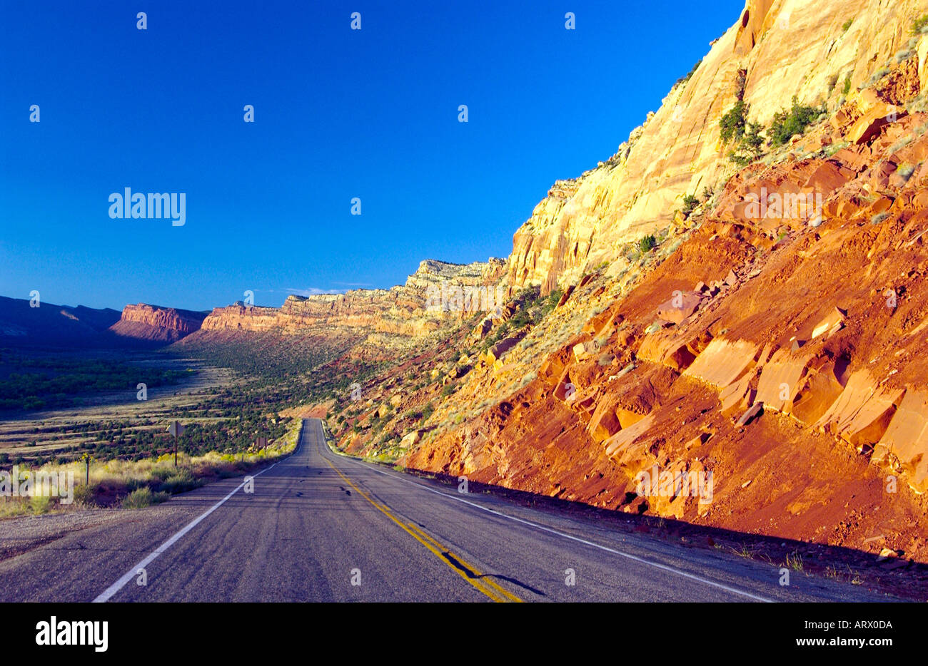 Hwy 95 and illuminated canyon walls at sunset near Blanding Utah USA ...