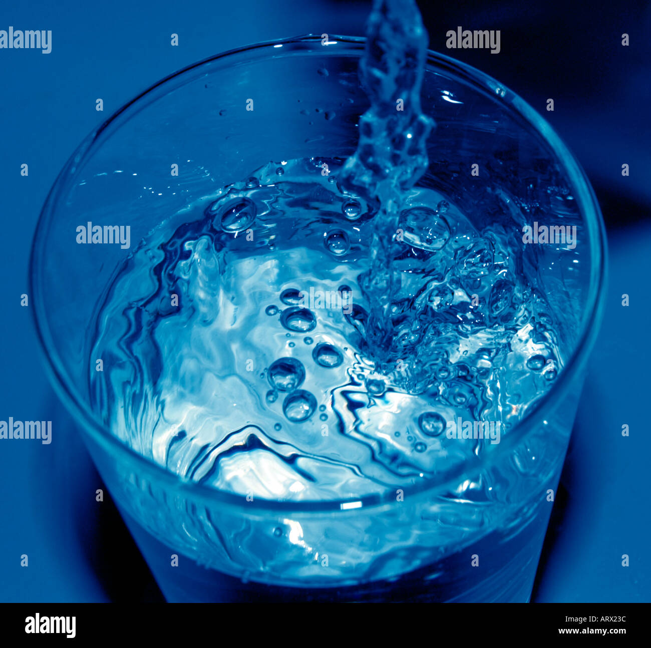 Drop of water landing in a glass Stock Photo - Alamy
