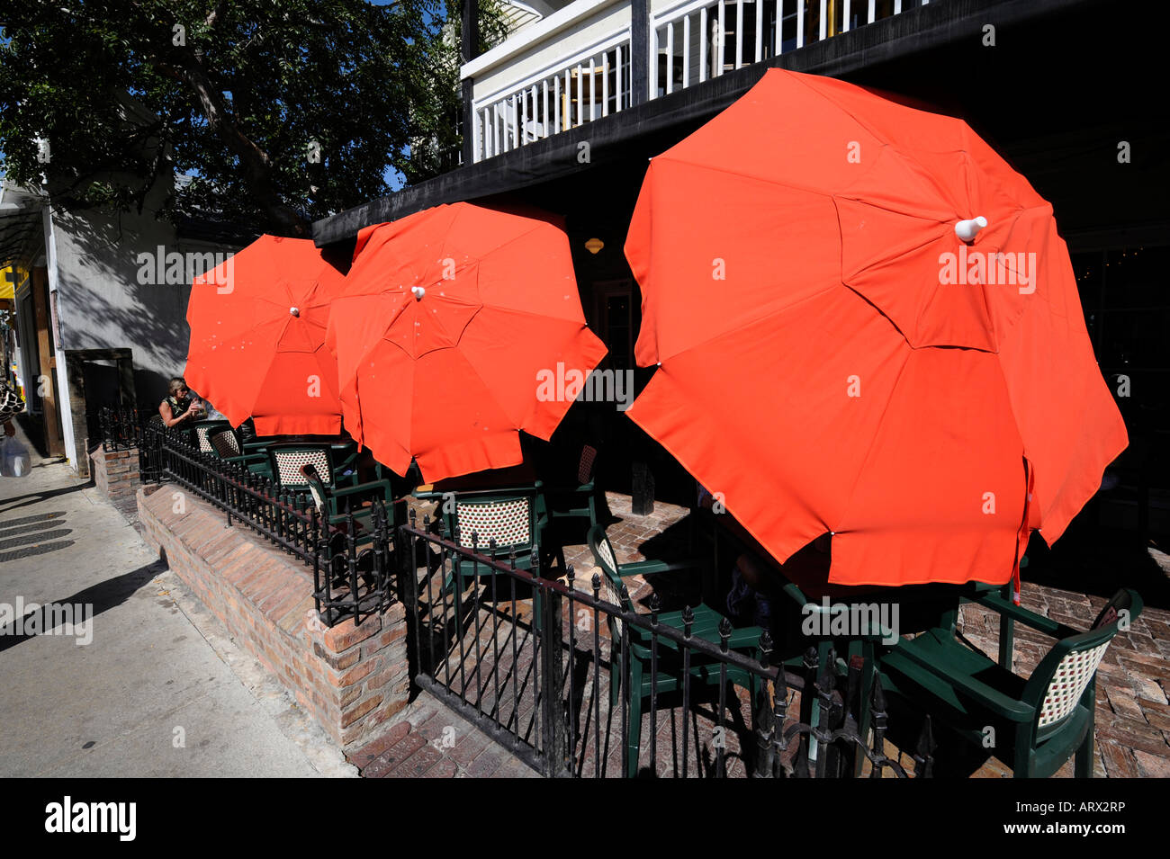 3 large red umbrellas protect patrons from sun at Key West Florida ...