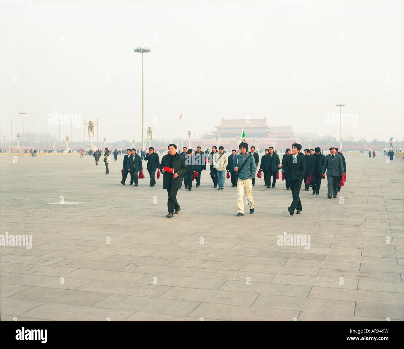 A tour group walking through Tienanmen Square in Beijing China Stock ...
