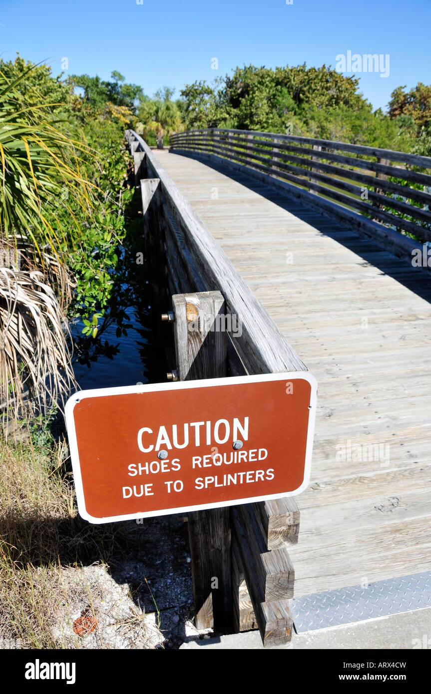 Warning sign on wood bridge across river at Lovers Key State Park ...
