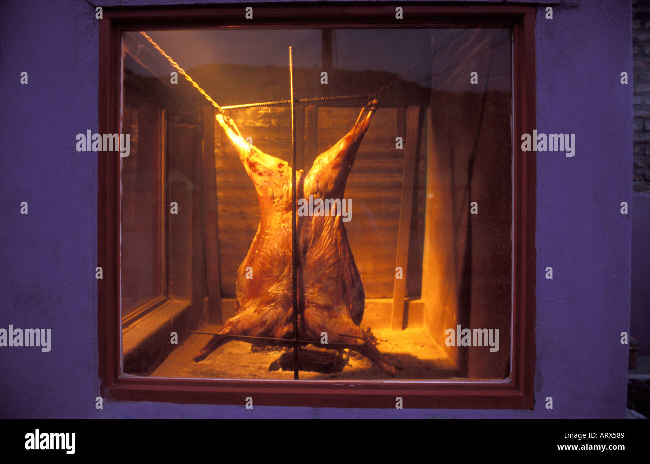 lamb roasting in restaurants barbecue pit. Patagonia Stock Photo - Alamy