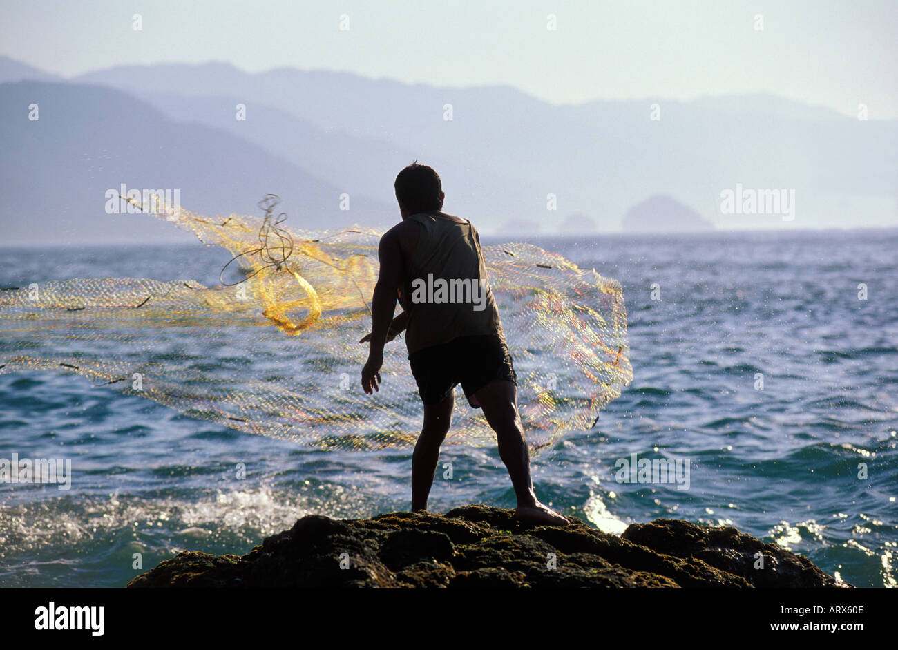 Man throwing rock into water hi-res stock photography and images - Alamy