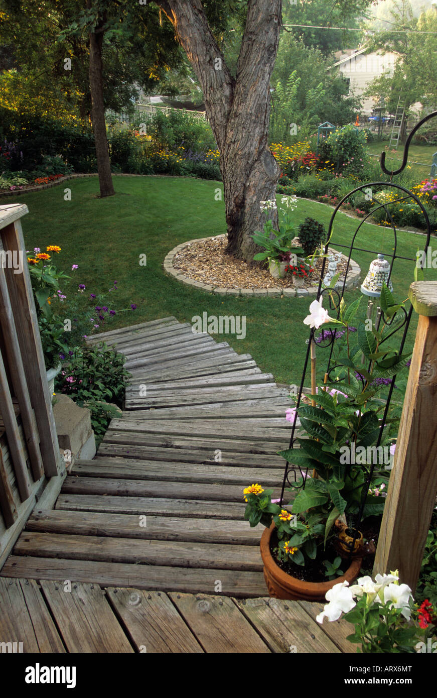 WOOD STEPS LEAD FROM DECK TO BACKYARD OF MIDWESTERN HOME Stock Photo ...
