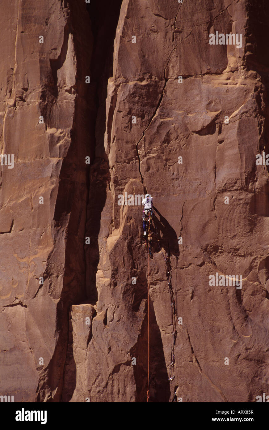Man climbing cliff face, Arches National Park Utah Stock Photo - Alamy