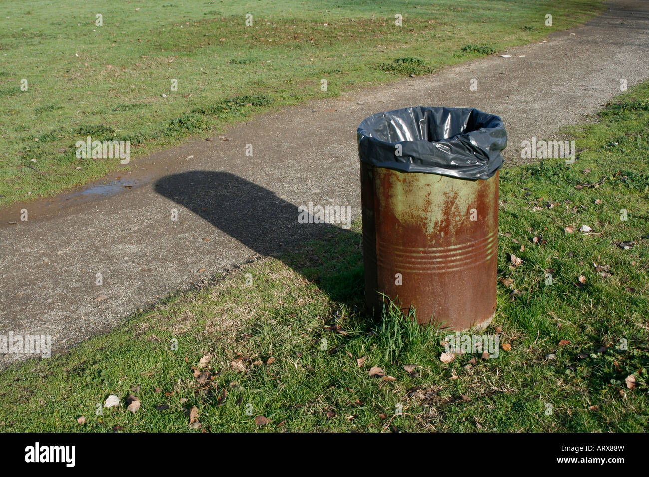 one dirty litter bin in park Stock Photo - Alamy