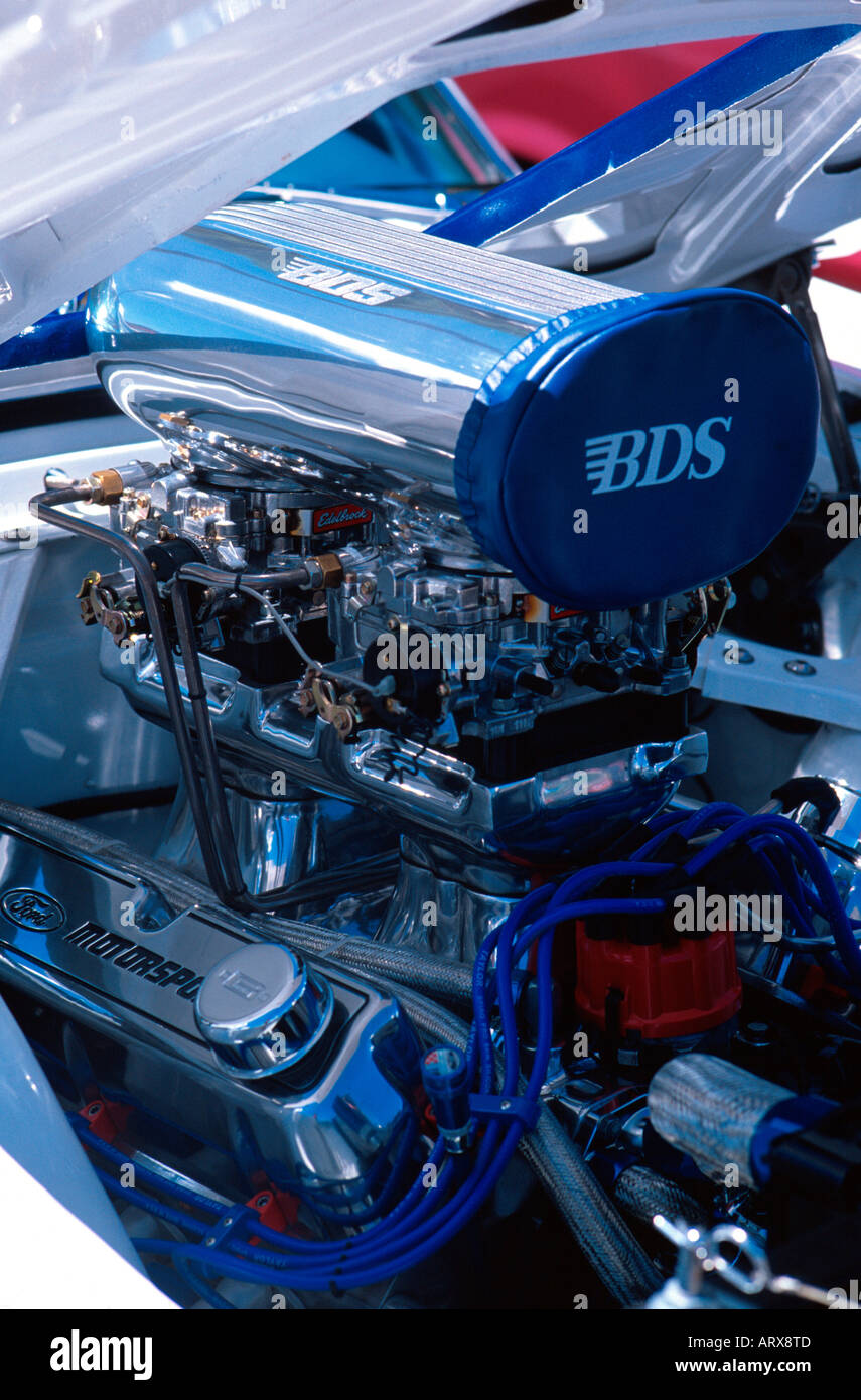 Under the hood of white and blue Ford Mustang immaculately clean engine ...