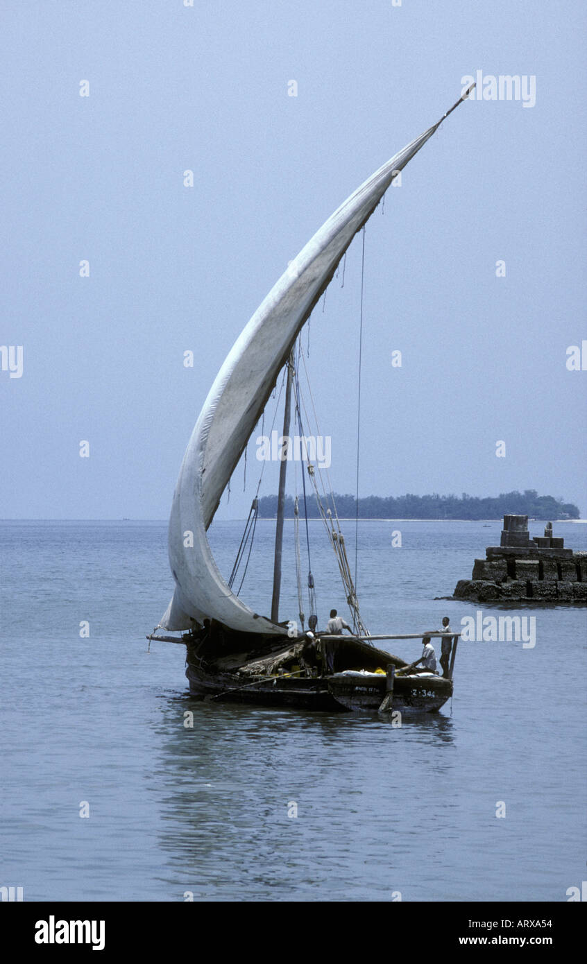 A traditional sailing boat or jahazi leaving the harbour of the stone ...