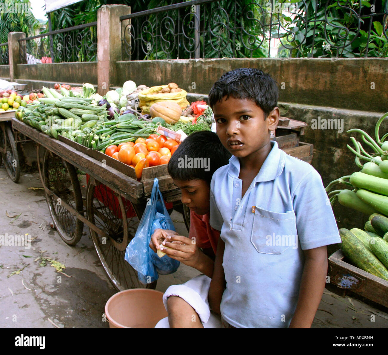 boys at vegetable market rishikesh india Stock Photo - Alamy