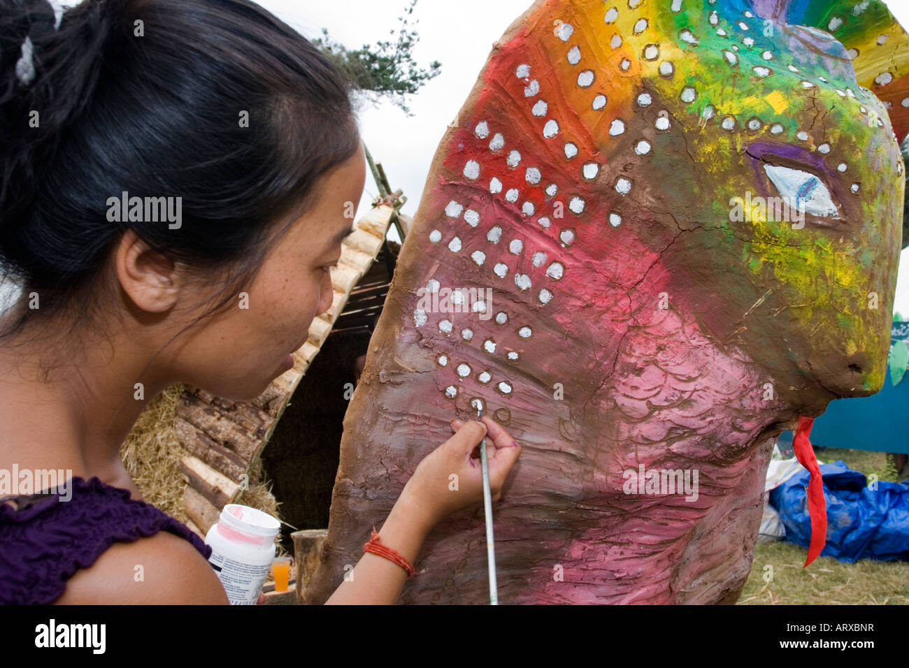 Lillian Sum, an artist from Devon, puts the finishing touches to an ...