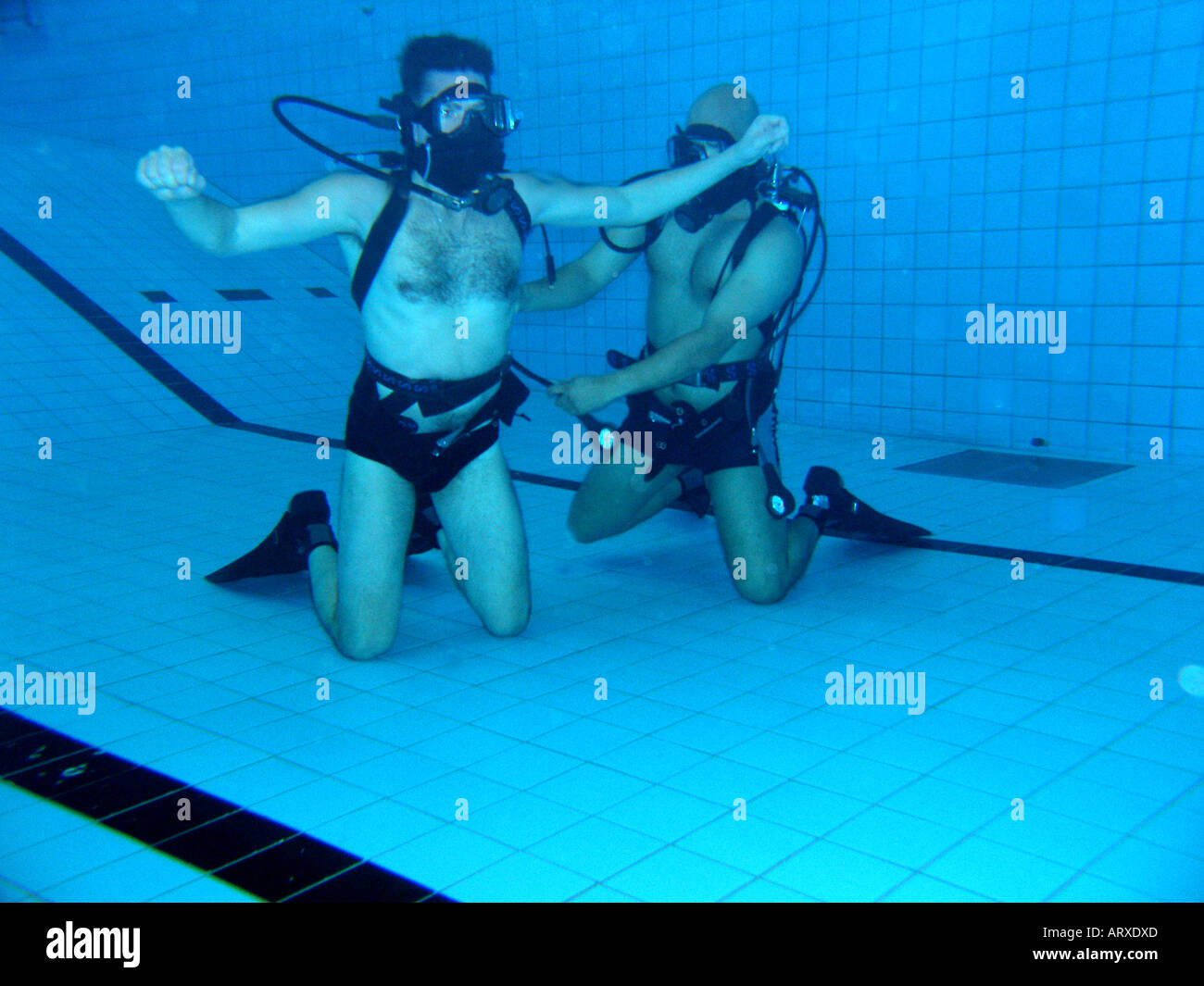Practise underwater rescue in swimmingpool Stock Photo - Alamy