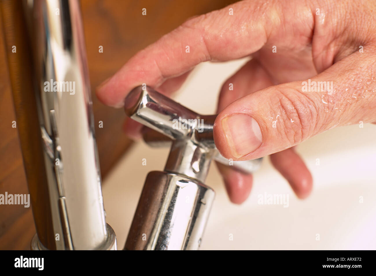 Man turning tap hi-res stock photography and images - Alamy