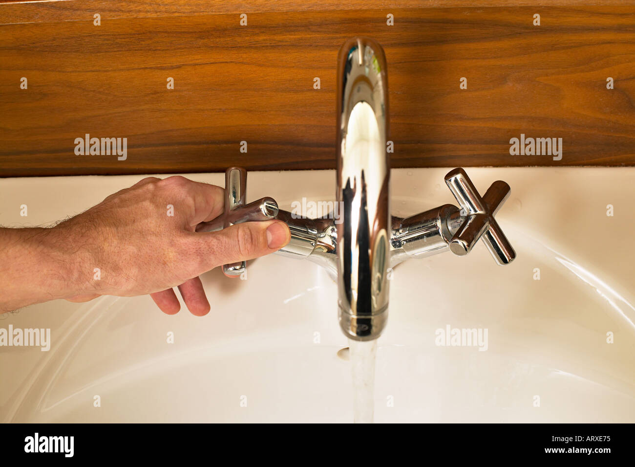 man washing hands turning tap running water hygiene Stock Photo - Alamy